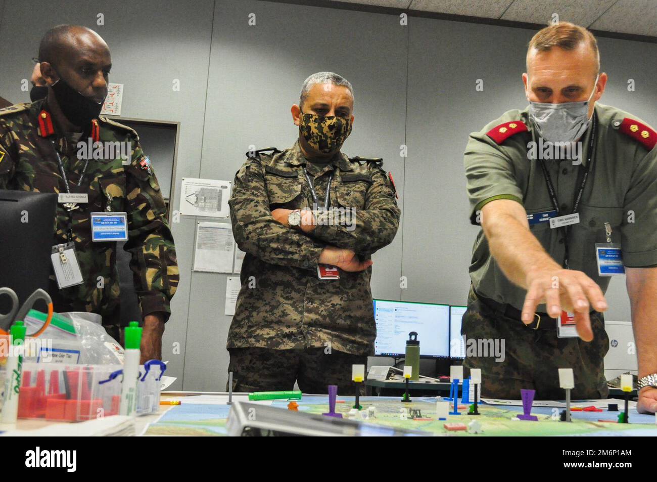 Kenyan COL Alfred Gitonga and Tunisian LTC Helmi Bedoui observe Finnish COL Timo Hanninen's ...