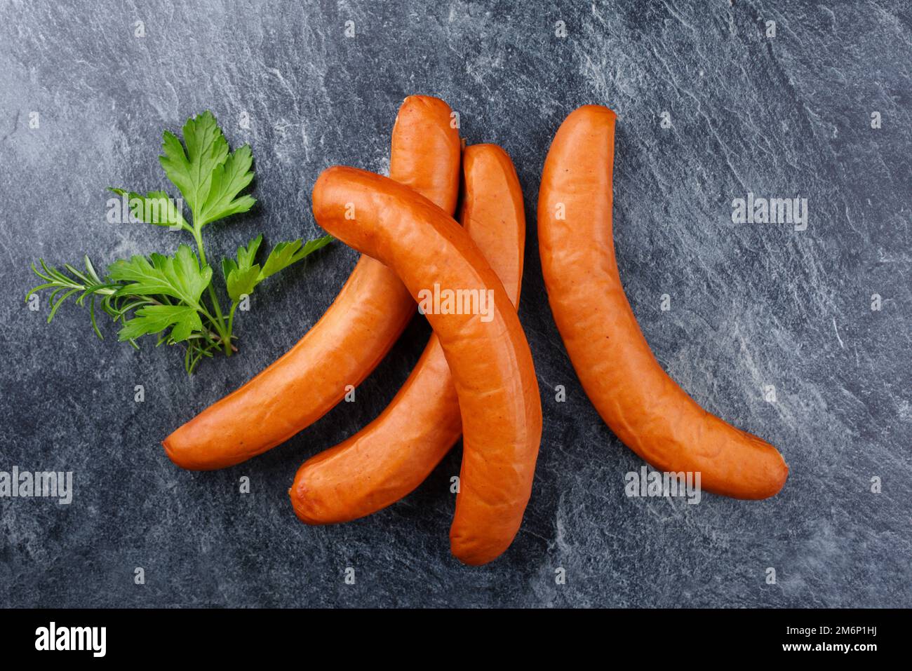 Traditional raw German bockwurst offered as top view on a gray ...