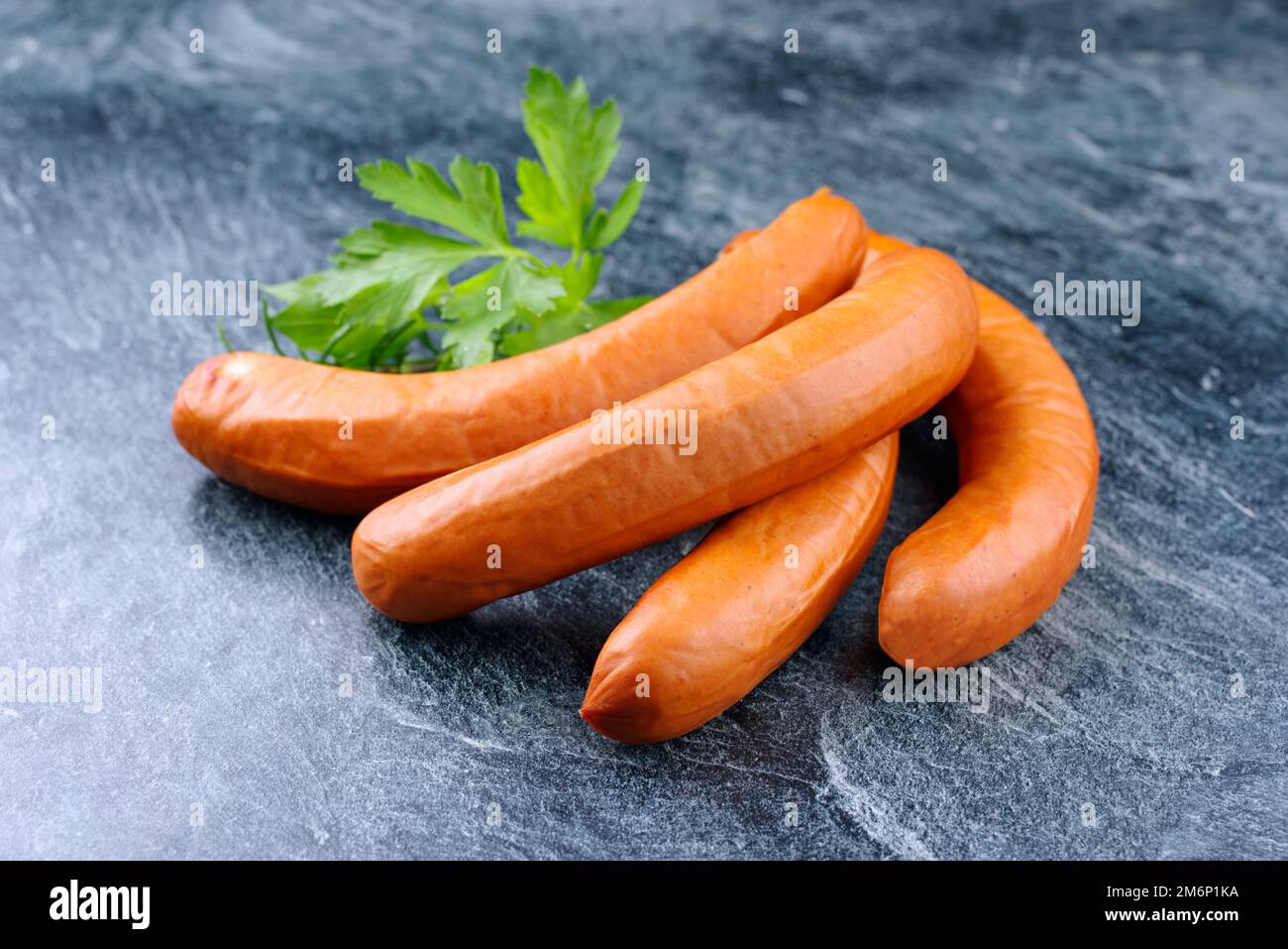 Traditional raw German bockwurst offered as close-up on white ...