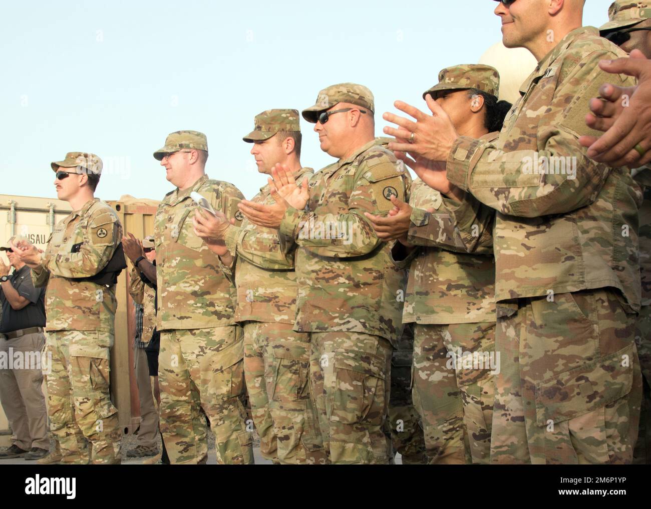 Soldiers assigned to 3rd Expeditionary Sustainment Command clap after ...