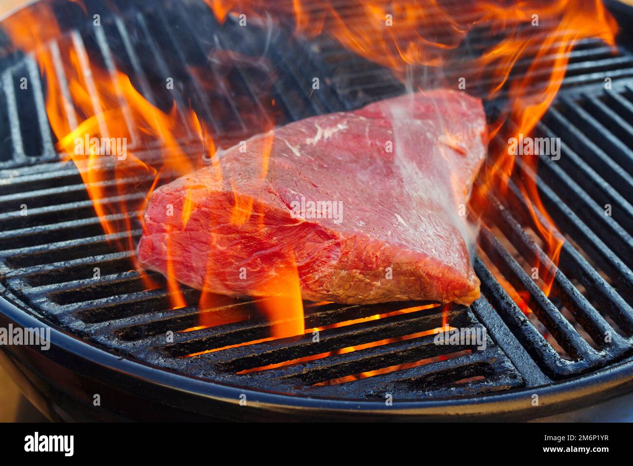 Raw BBQ wagyu sirloin cap of rump beef steak grilled as close-up on a ...