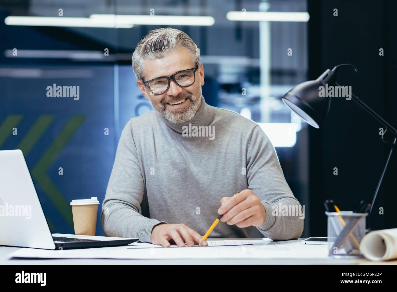 Portrait of senior architect, gray haired designer smiling and looking ...