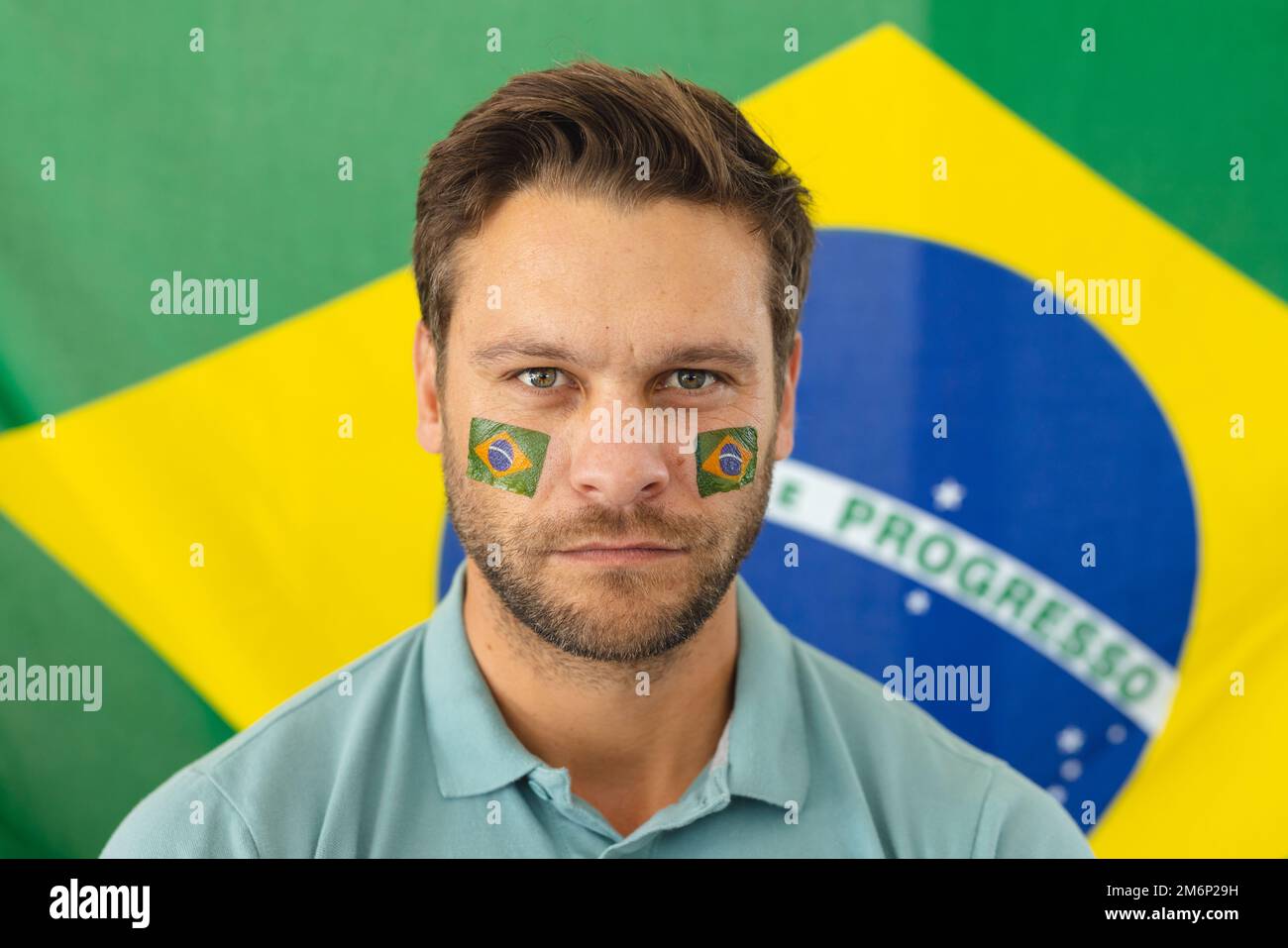 Image of happy caucasian man with flags of brazil on face over flag of ...
