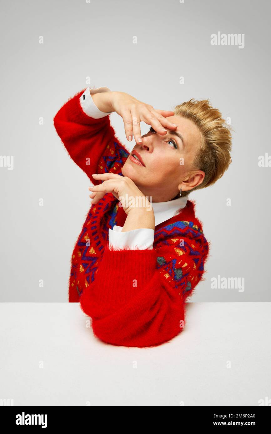 Extravagant, stylish and fashionable mature woman posing isolated over ...