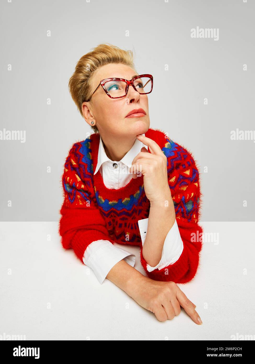 Extravagant, stylish and fashionable mature woman posing isolated over ...
