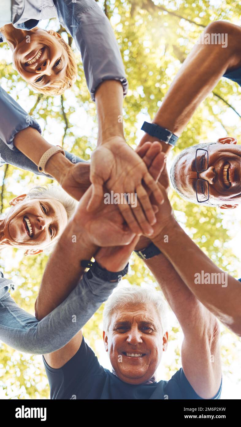 Senior hands, together and support with solidarity outdoor and group ...