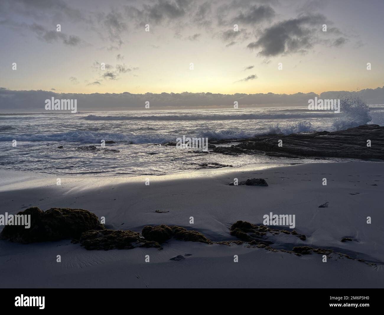 A beautiful sandy beach with splashing waves of the sea in the ...