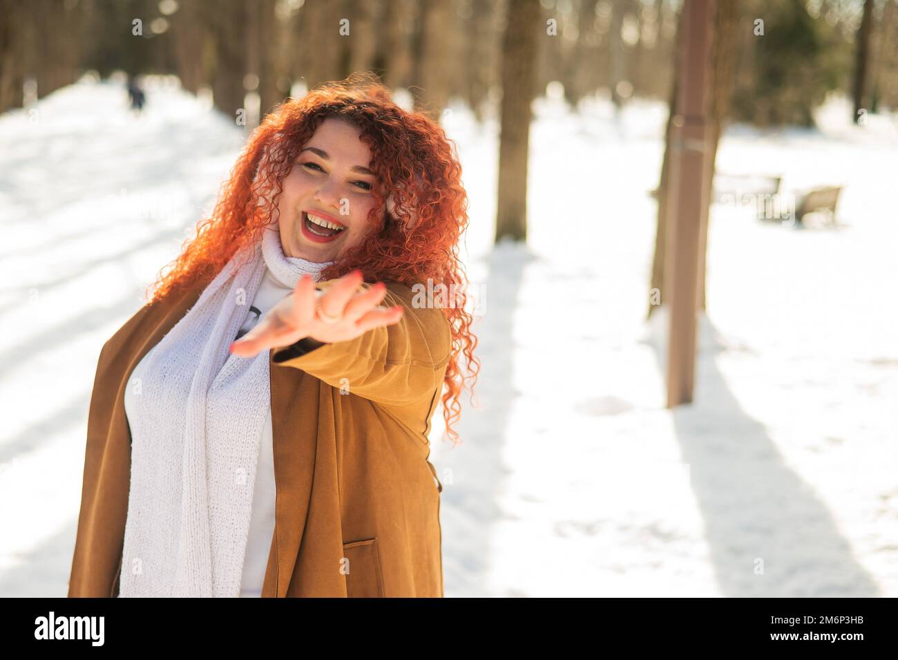 Cheerful fat caucasian woman walks in the park in winter Stock Photo ...