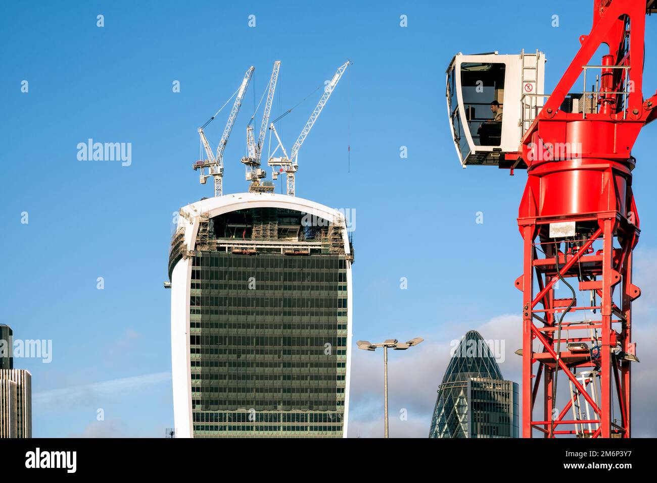 Red crane operating in London Stock Photo - Alamy
