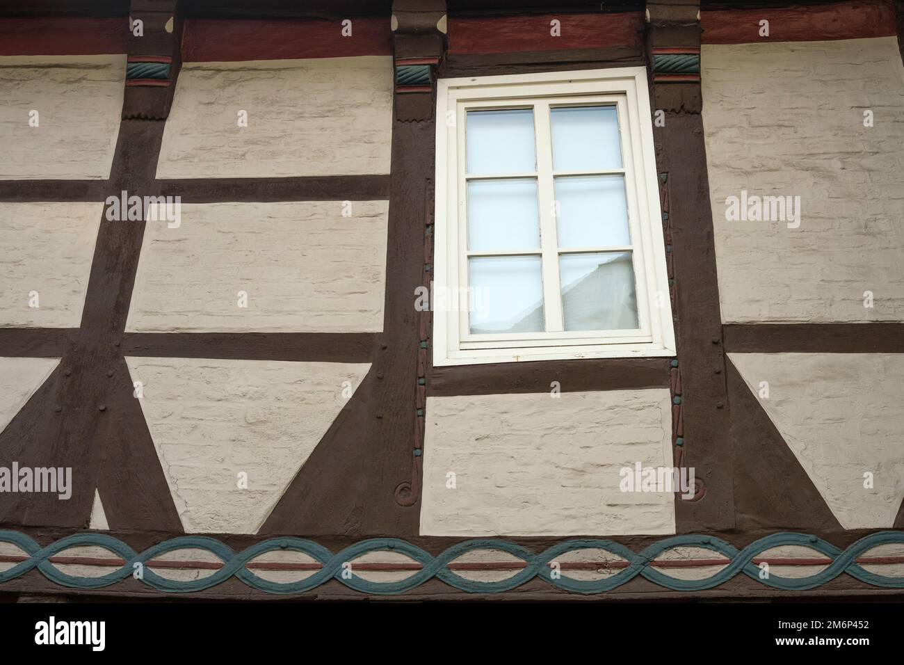 Crooked half-timbered house with small white window Stock Photo - Alamy