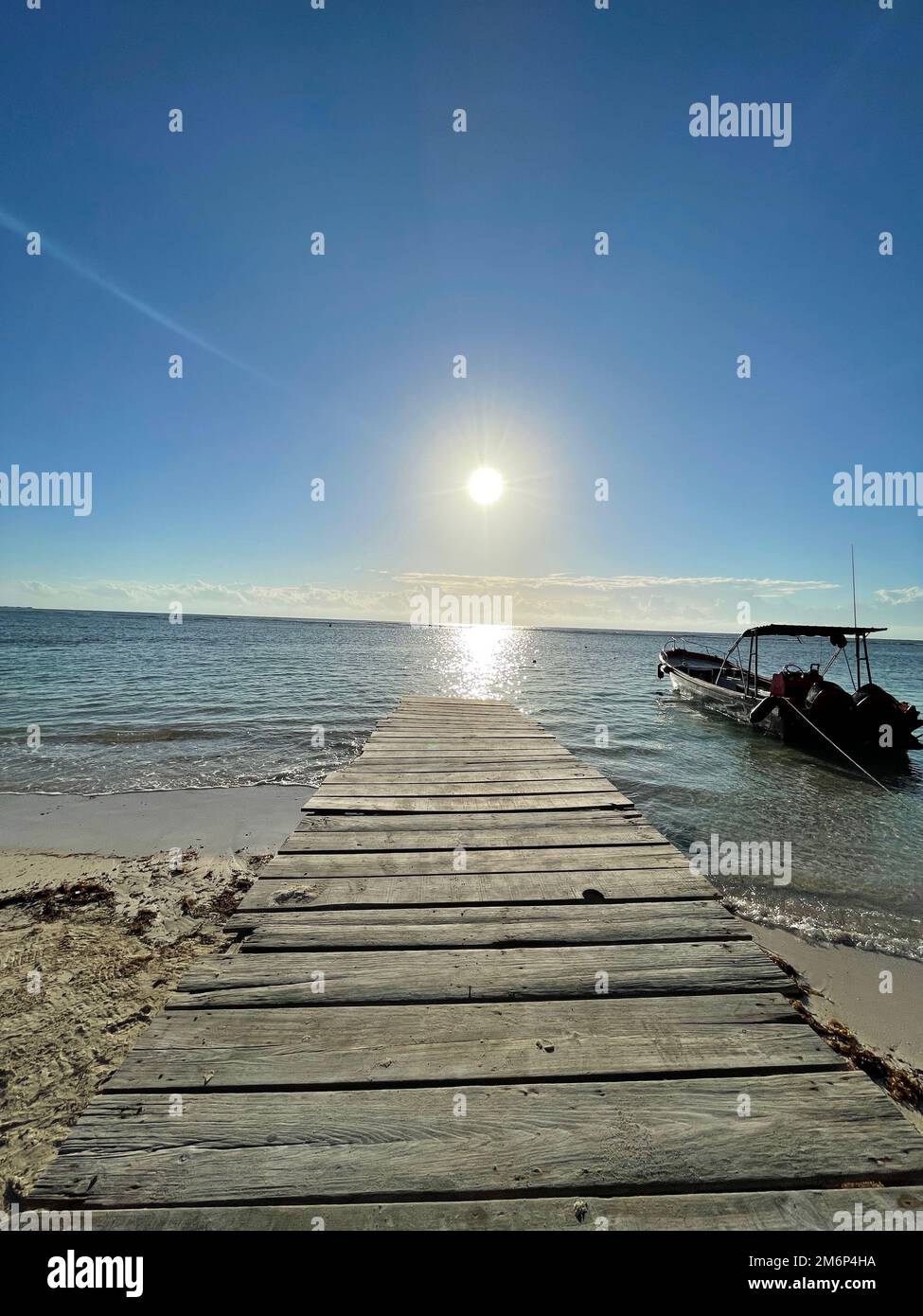 An image of a bridge on the blue sea from the beach under the sunlight ...