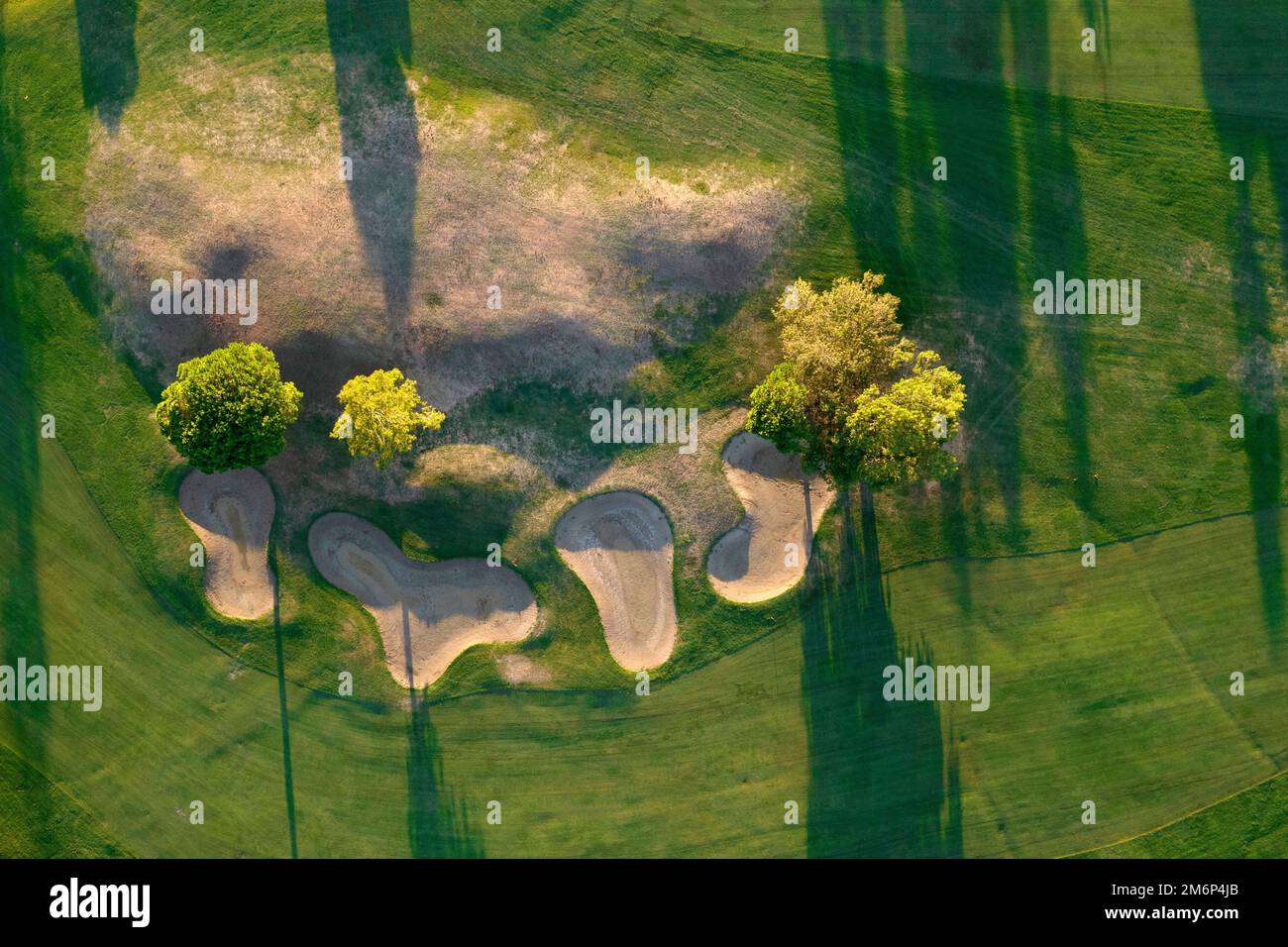 Aerial view of a green golf course at sunset Stock Photo - Alamy