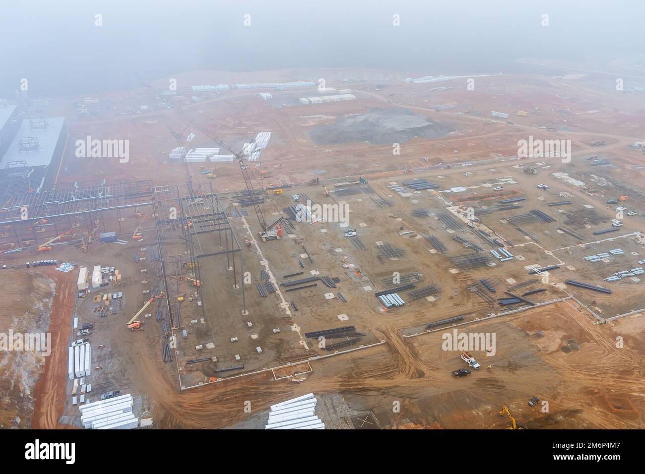 Construction site at dawn in morning when heavy fog is present, when ...