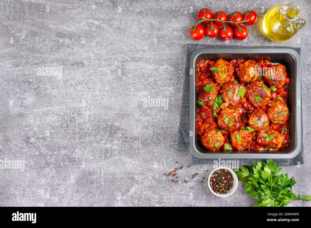 Homemade meatballs with tomato sauce and spices served in black pan on ...