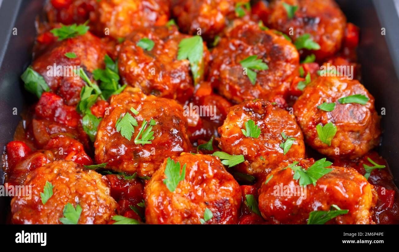 Homemade meatballs with tomato sauce, spices and fresh green parsley in ...