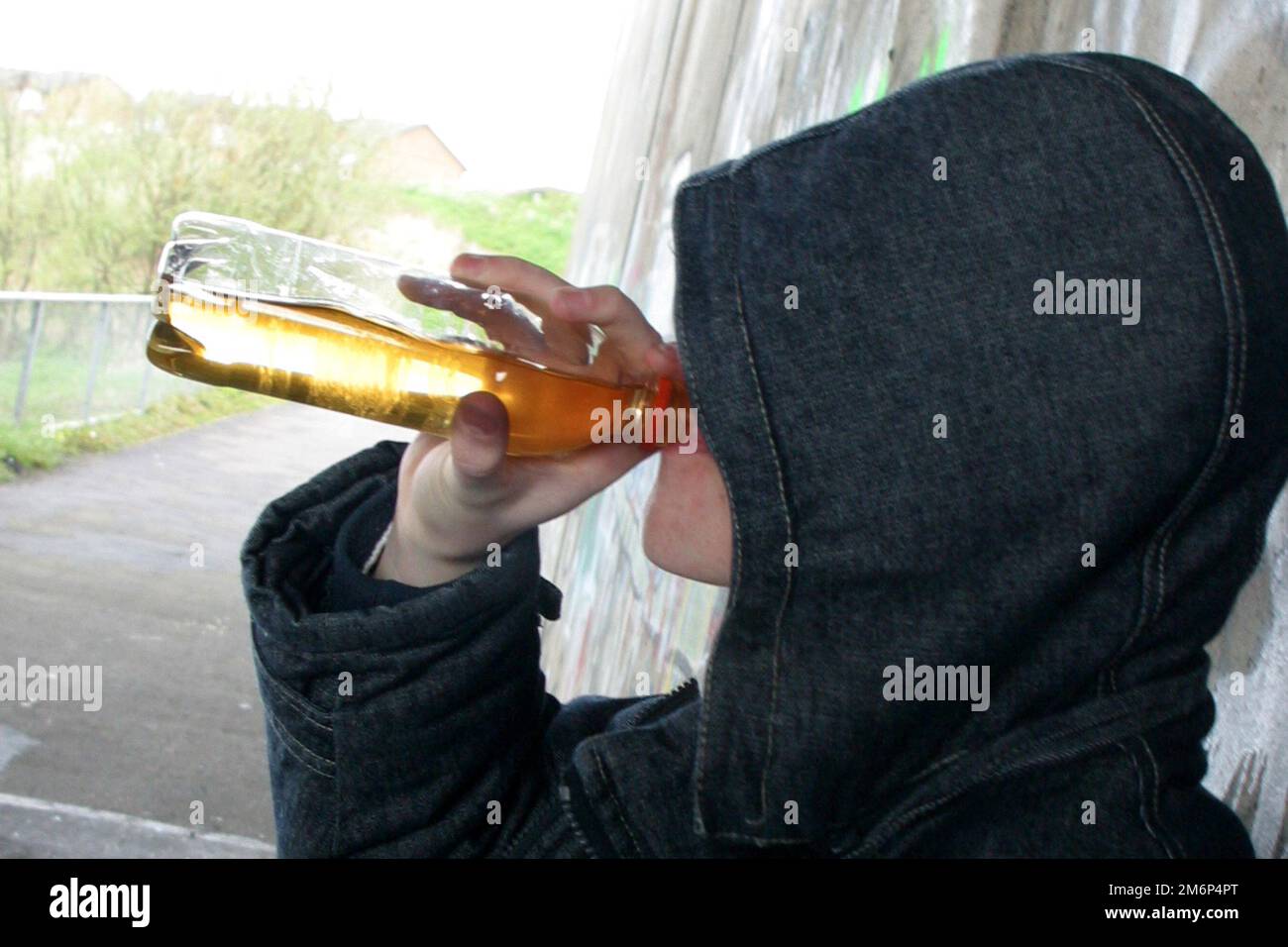 Irvine, Ayrshire, Scotland, UK. Hooded Youths loitering drinking and ...