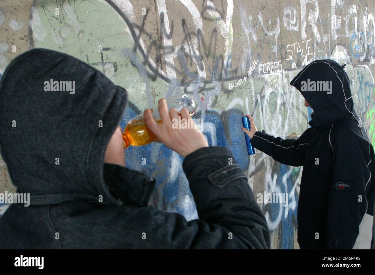 Irvine, Ayrshire, Scotland, UK. Hooded Youths loitering drinking and ...