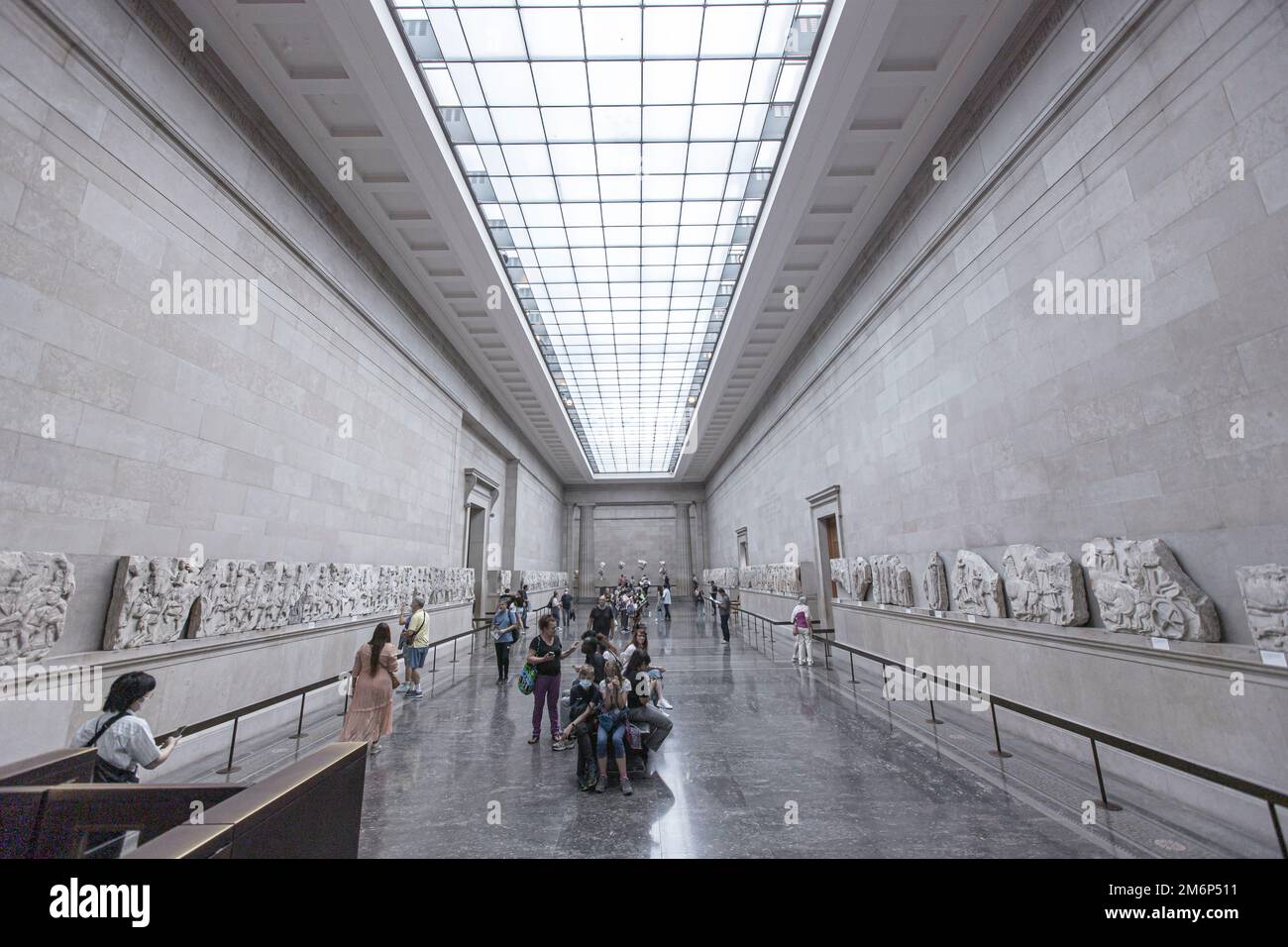 Visitors admire the Parthenon Marbles inside the Parthenon Galleries in the British Museum. In ...