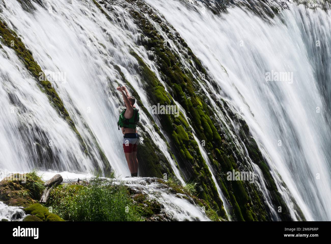 Waterfall extreme brave man as superhero running jump and dive from the ...