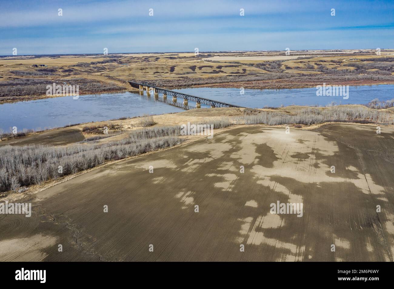 An aerial shot of a wide field and a bridge over the South Saskatchewan ...
