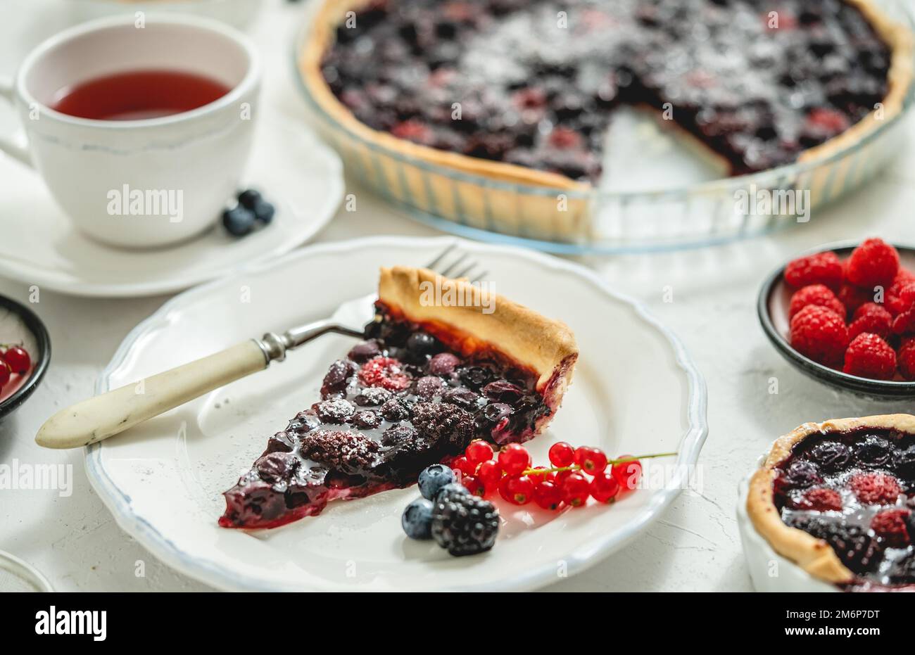Sweet dessert with fresh baked forest fruit pie served with raspberry ...