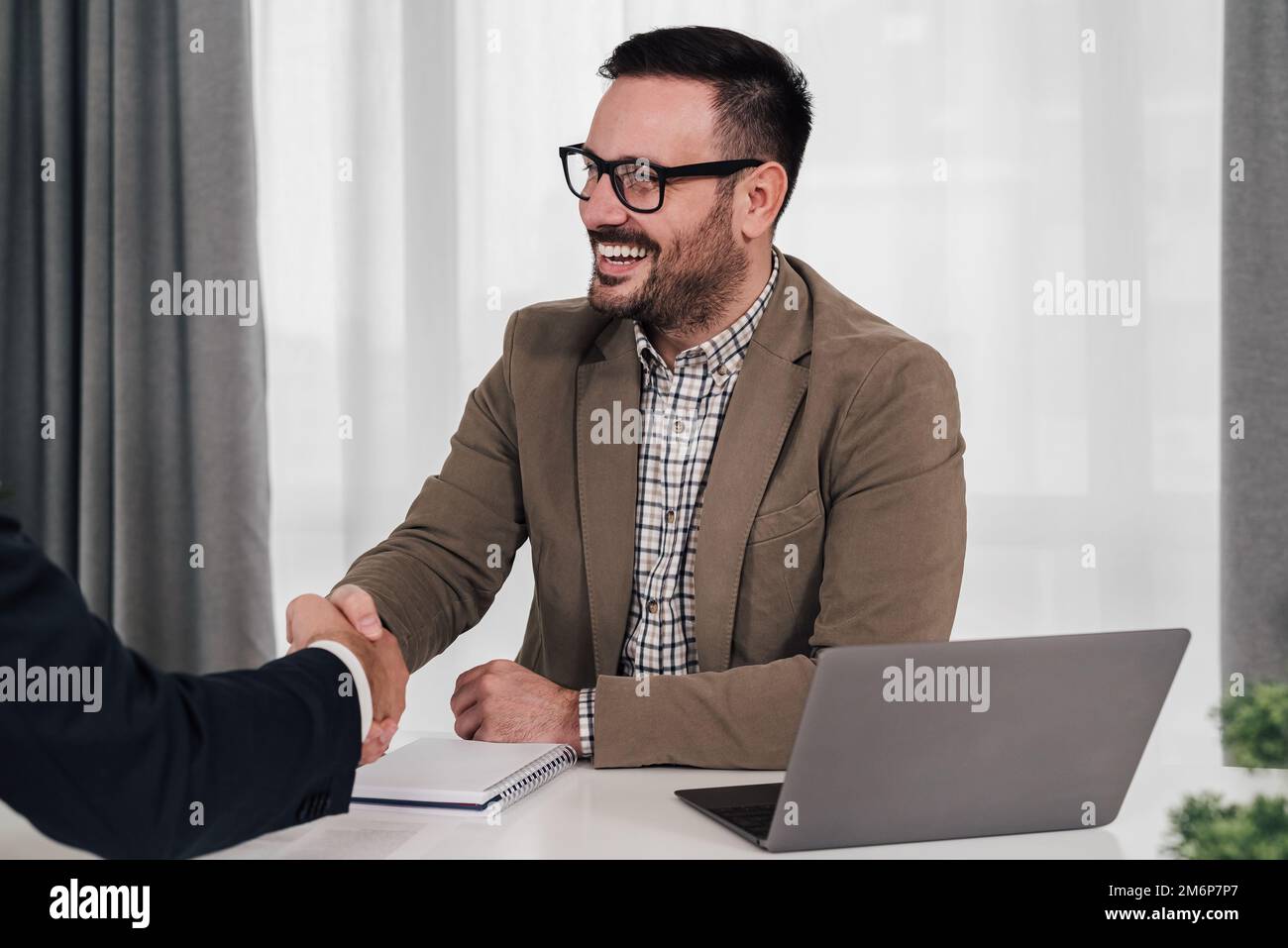 Happy adult businessman, shaking hands after a successful business deal ...