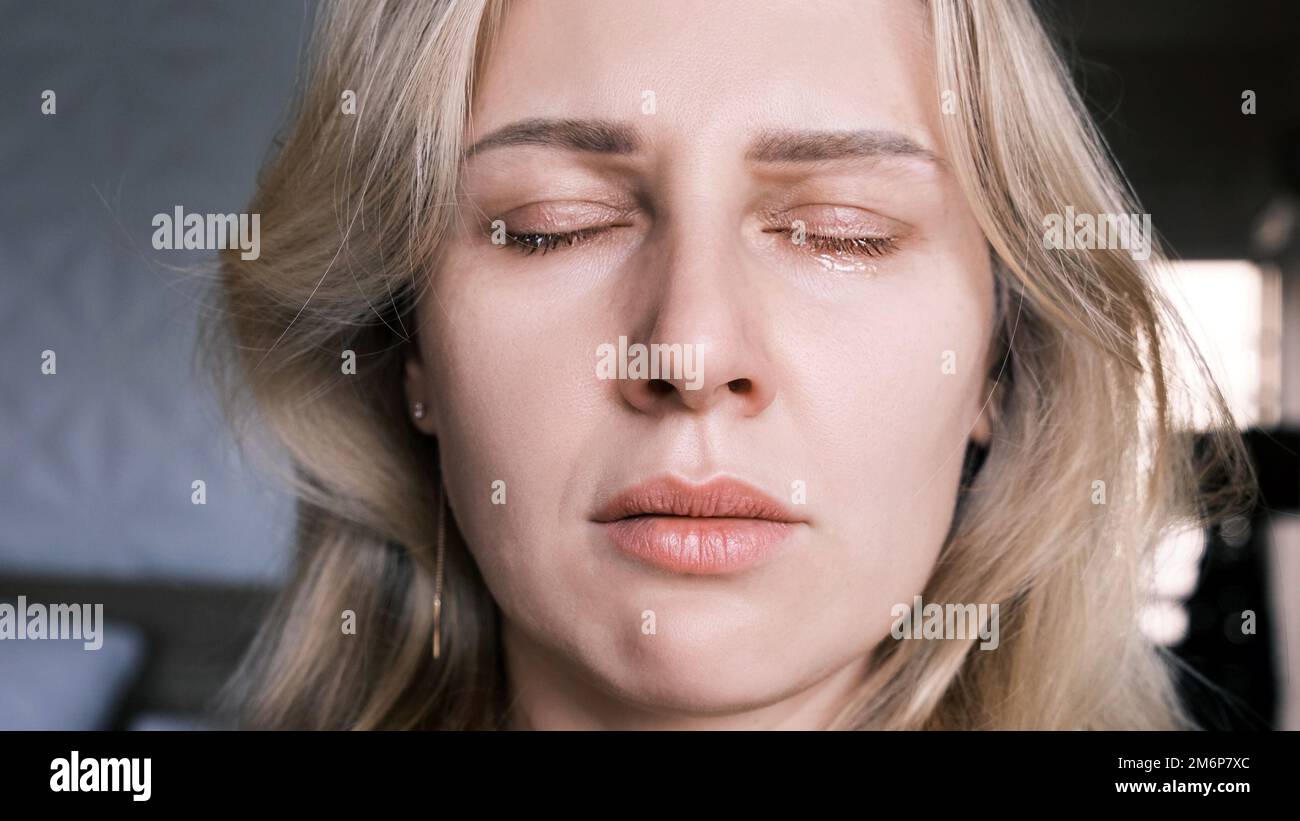 Portrait of crying grieving woman of 30 years. Grimace of sadness with ...