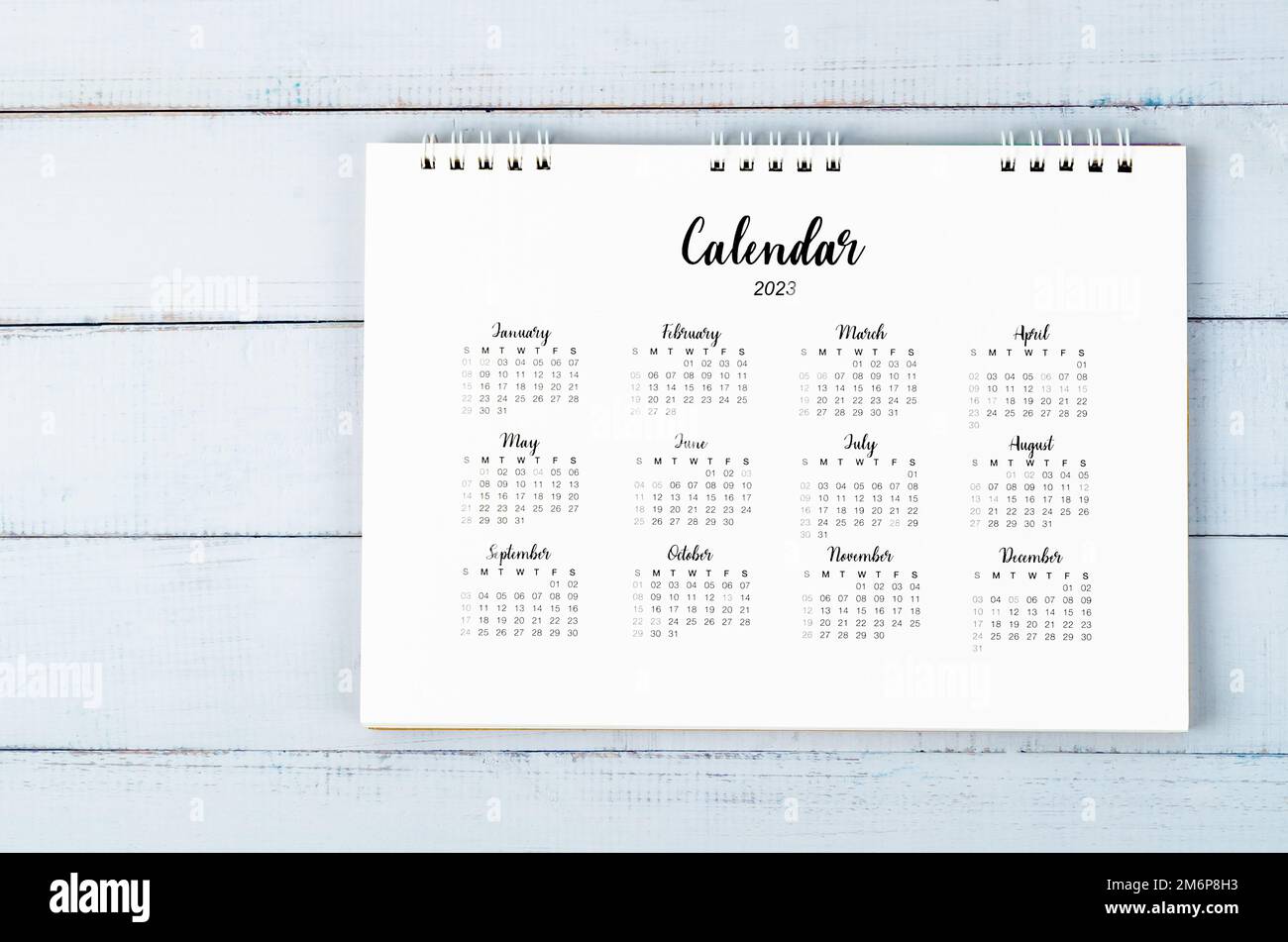 12 months desk calendar for 2023 year on a wooden background planning ...