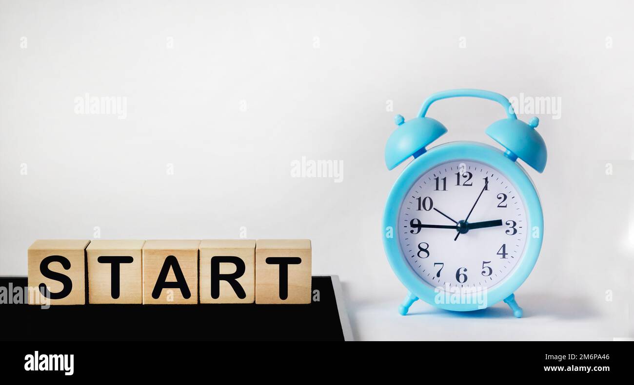 the word start wooden blocks and white and black background, next to ...