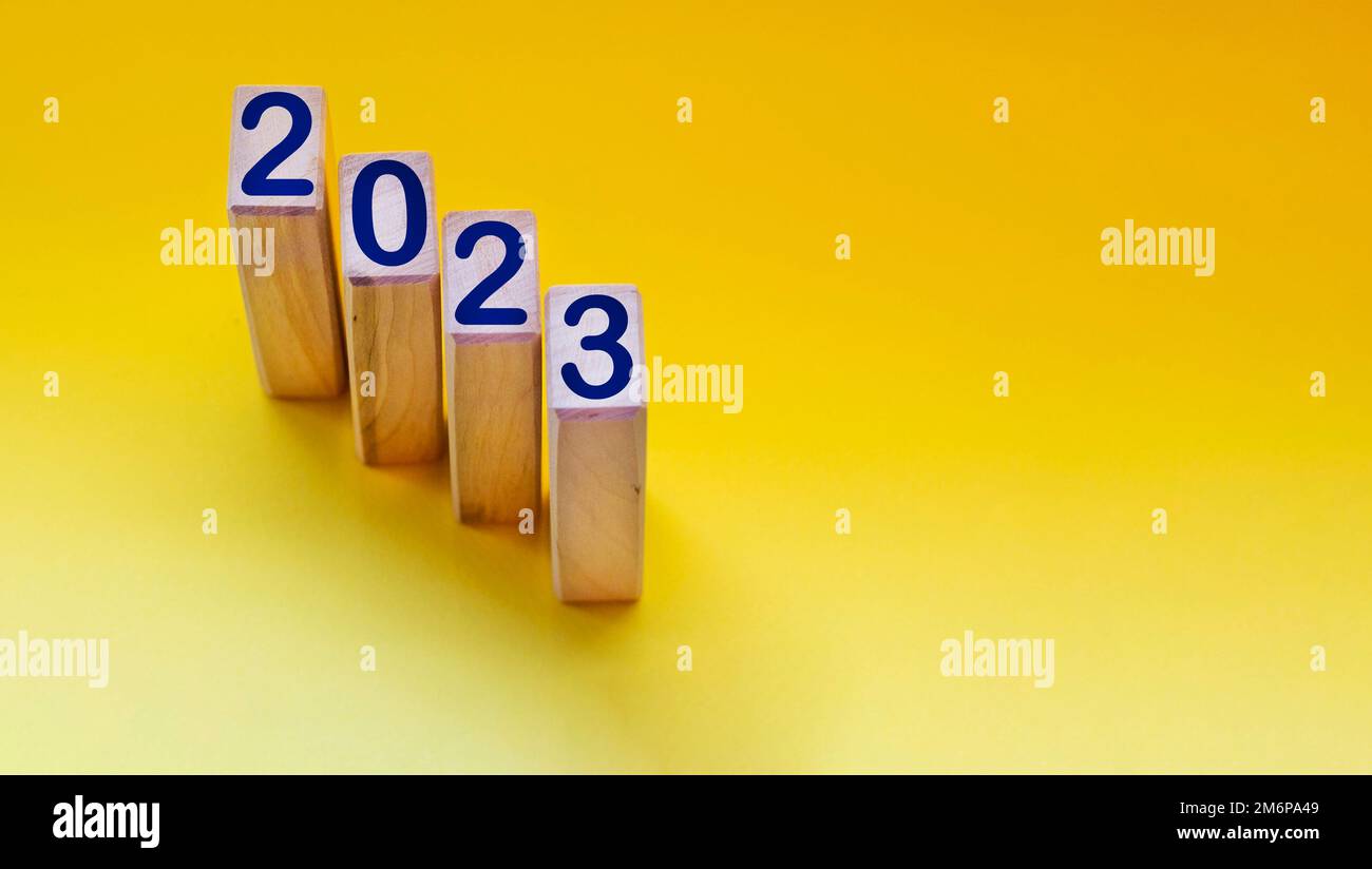 Blocks with the number 2023 on a yellow background. Business goals for ...
