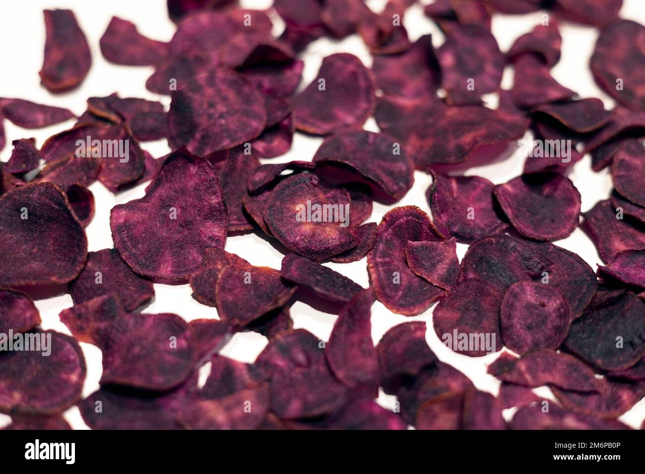 Dried purple sweet potatoes on the white background Stock Photo - Alamy