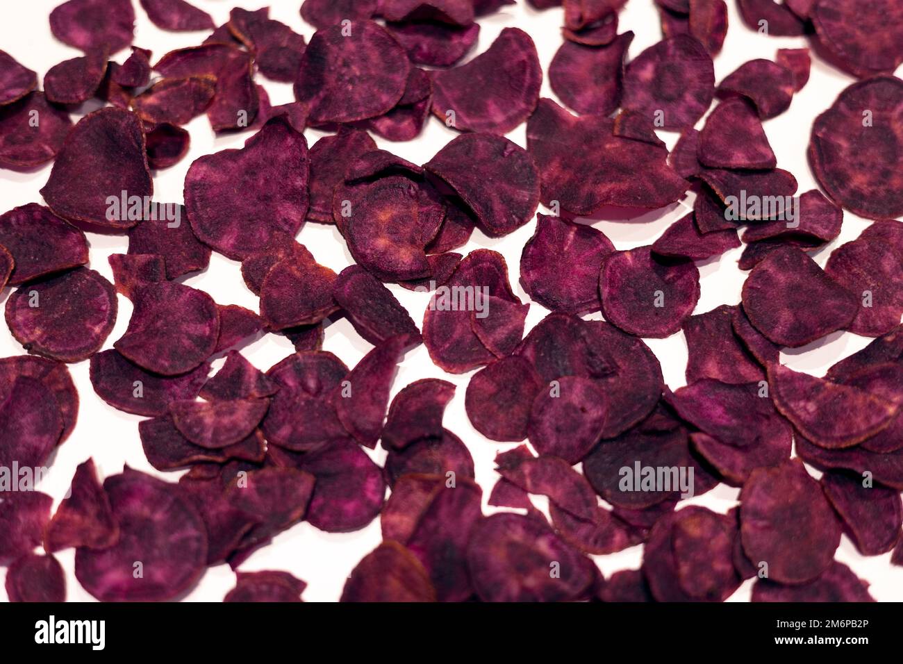 Dried purple sweet potatoes on the white background Stock Photo - Alamy