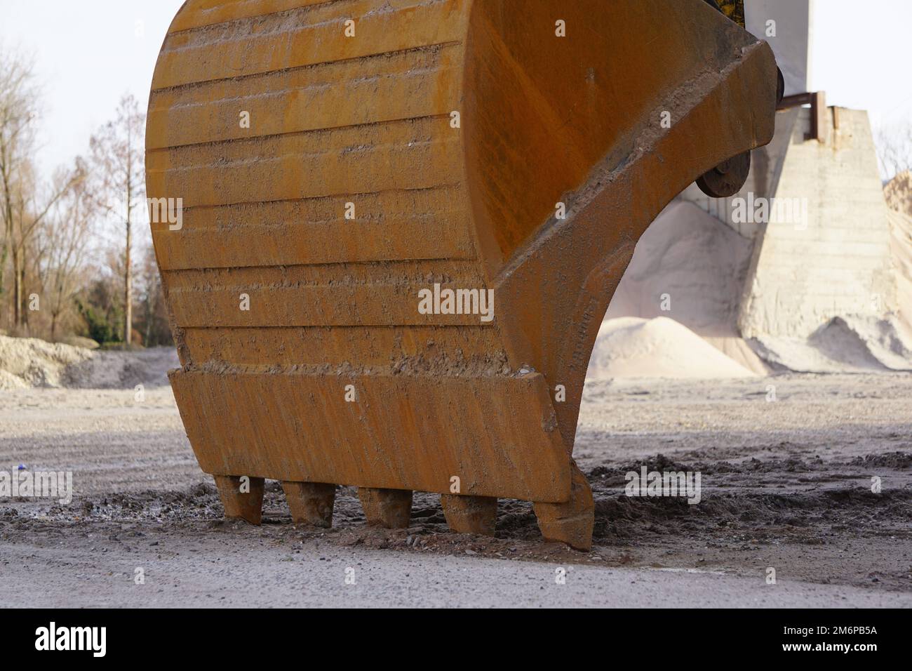 A closeup shot of the bucket of an excavator digging a basement on a ...