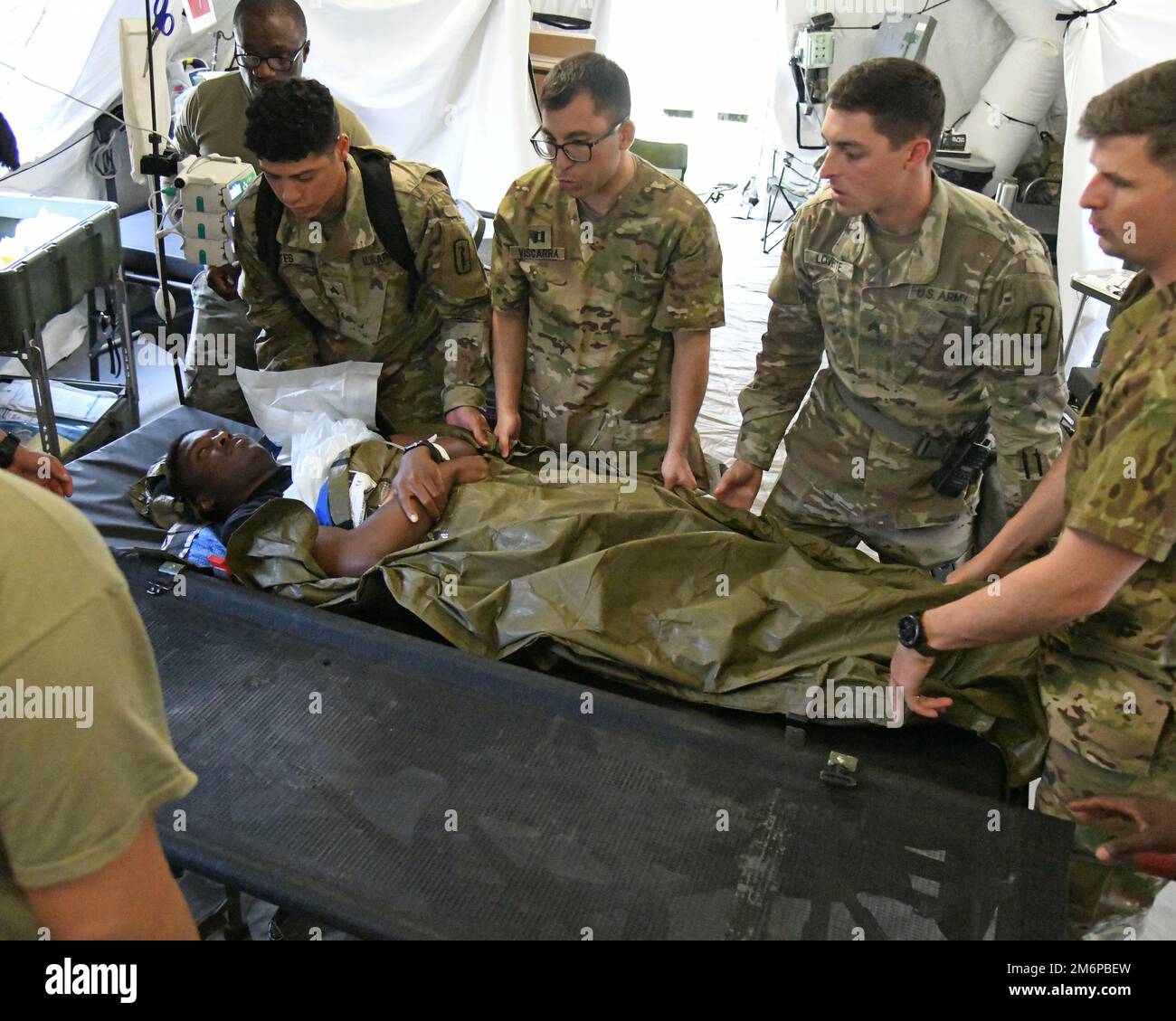 U.S. Army medical professional with the 512th Field Hospital move a ...