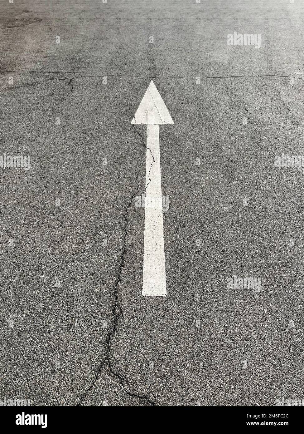 Go straight arrow on the road Stock Photo - Alamy