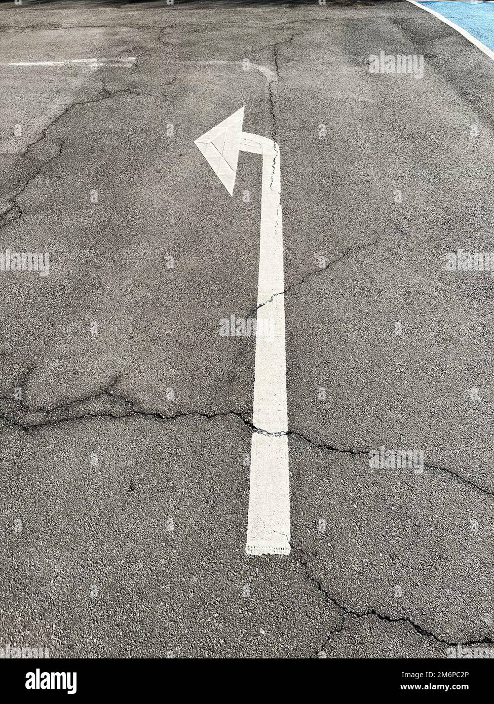 Left arrow on the road Stock Photo - Alamy