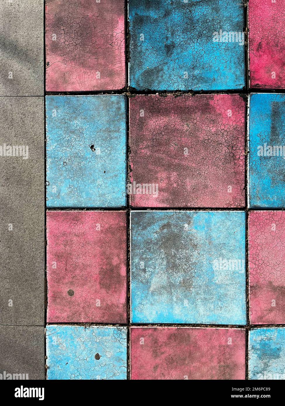Sidewalk with pink and blue blocks Stock Photo - Alamy