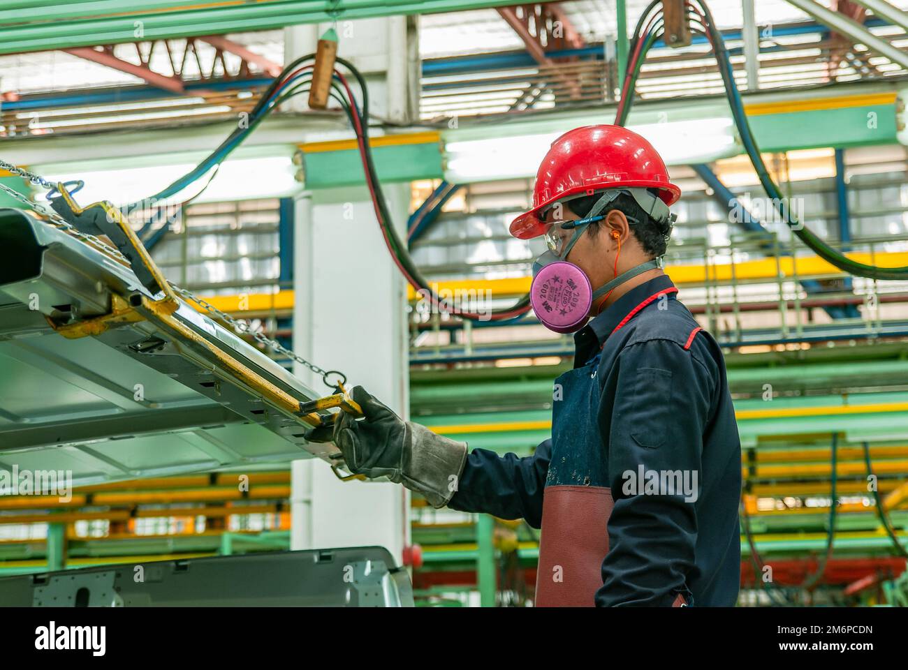 Worker at a truck assembly plant in Asia Stock Photo - Alamy
