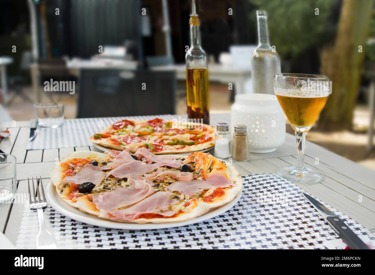 Pizza with ham and chorizo in a restaurant Stock Photo - Alamy
