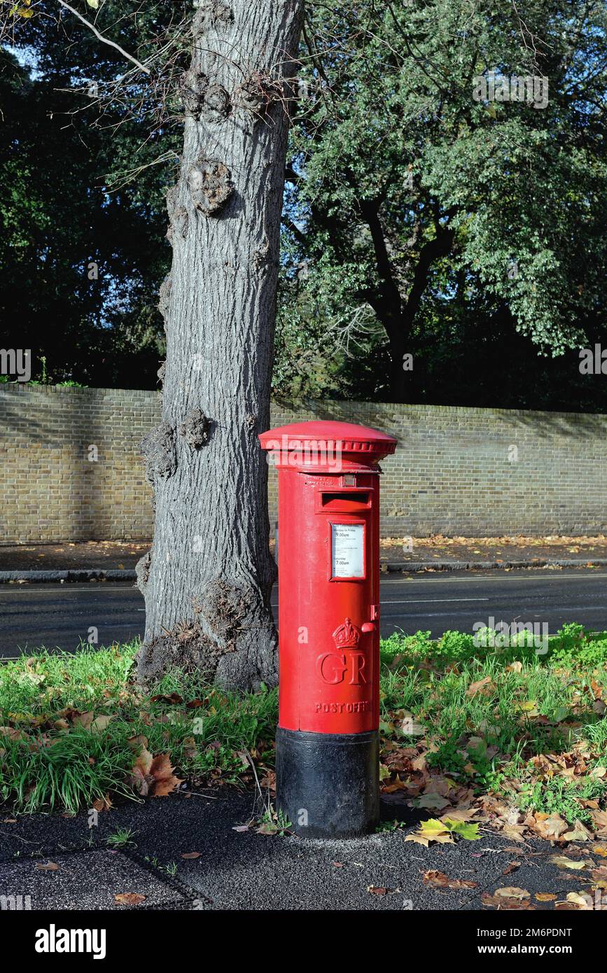 A Red Post Office pillar box by the roadside Kew London England UK ...