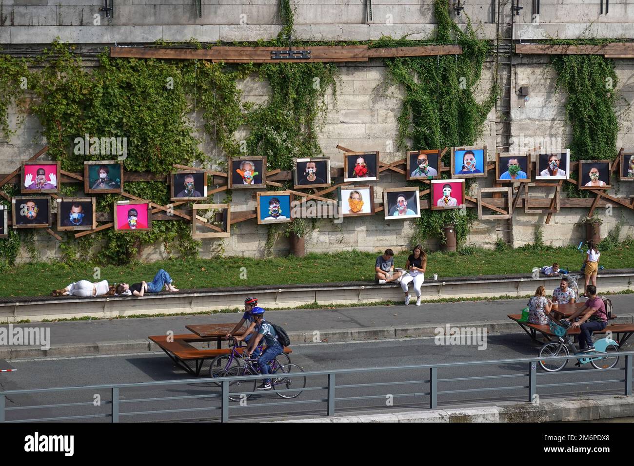 France, Paris, People relaxing and art exposition along the Seine river ...