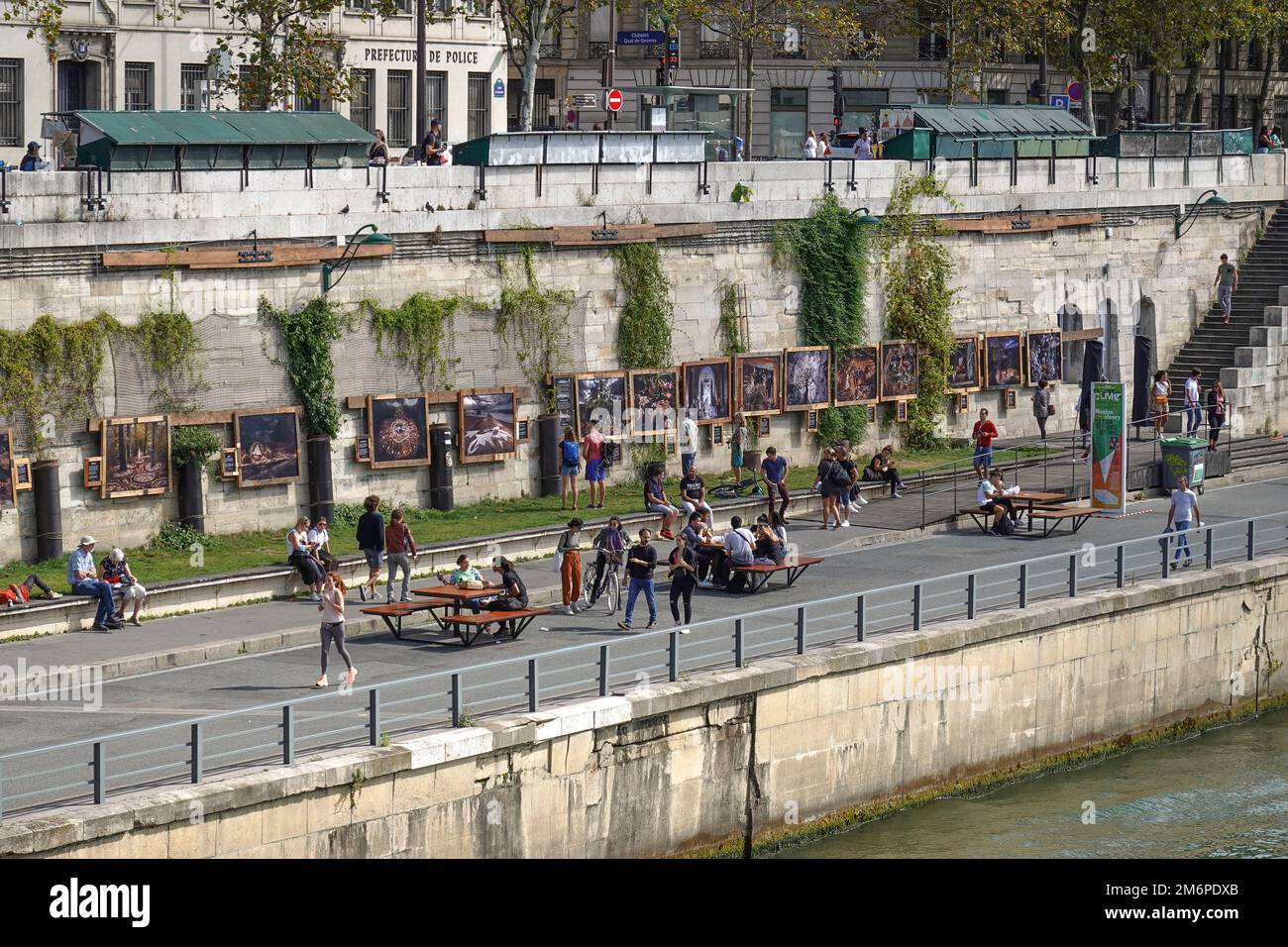 France, Paris, People relaxing and art exposition along the Seine river ...