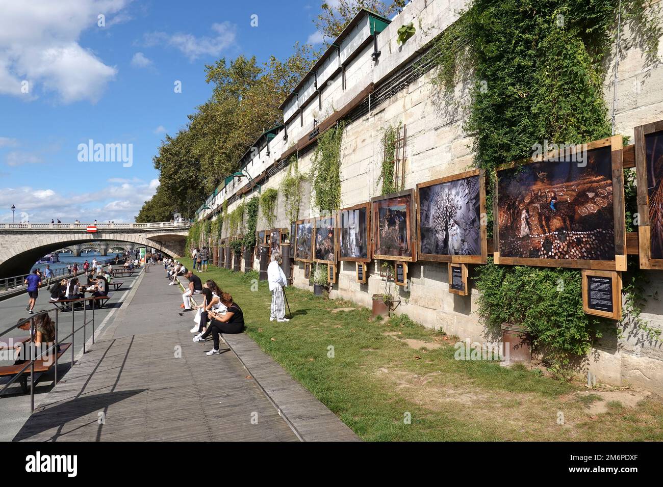 France, Paris, People relaxing and art exposition along the Seine river ...