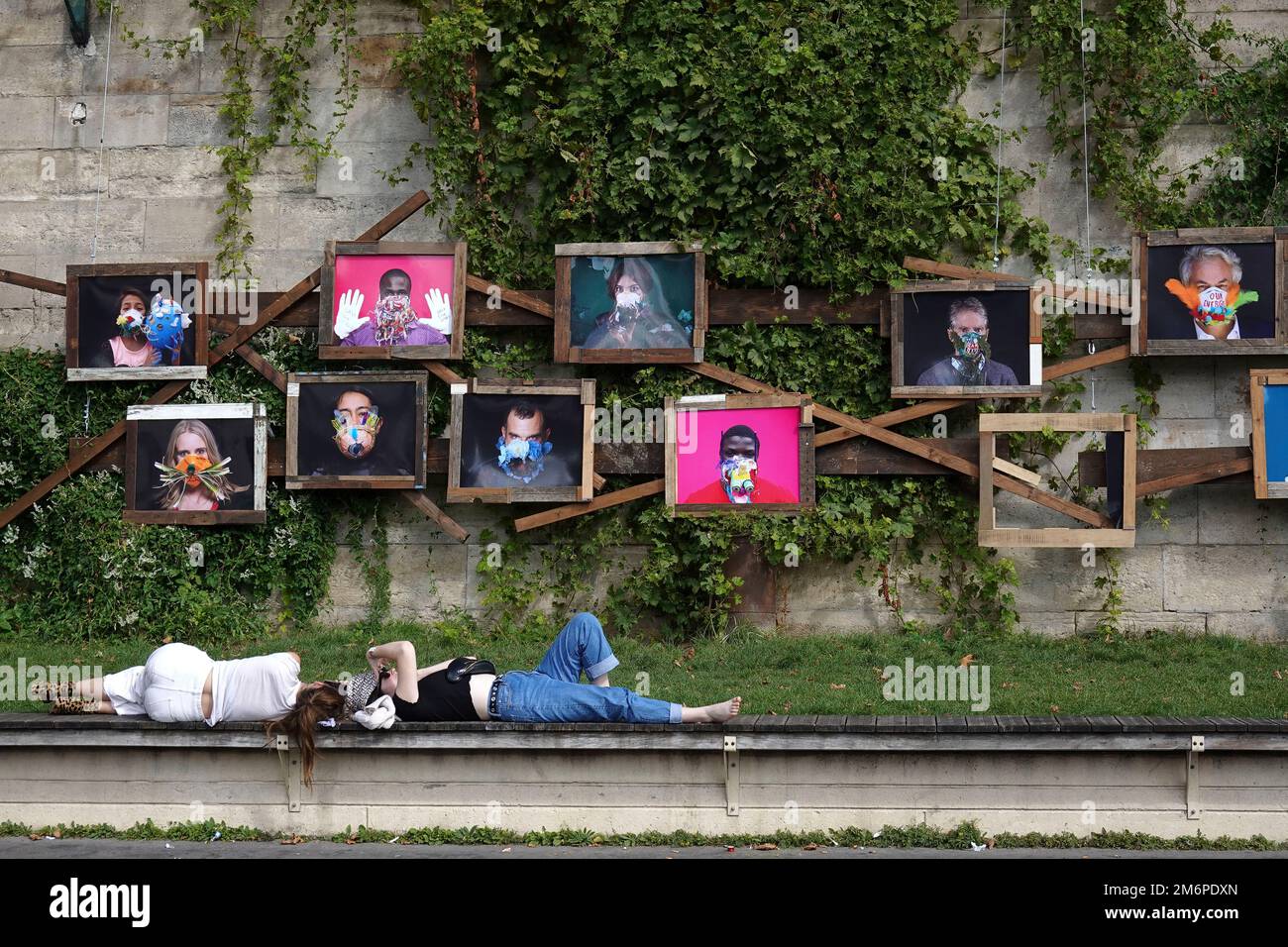 France, Paris, People relaxing and art exposition along the Seine river ...