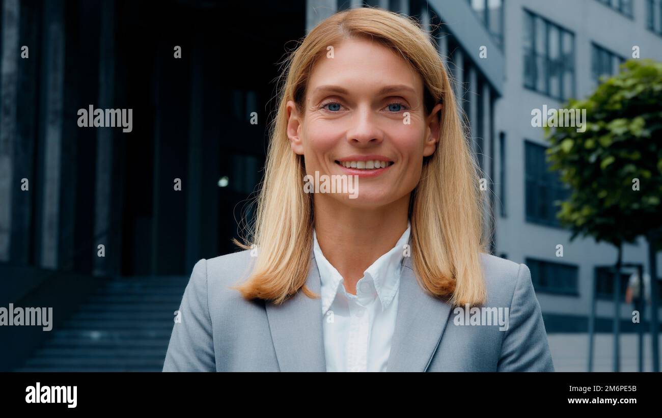 Female business portrait happy young smiling woman standing near office ...