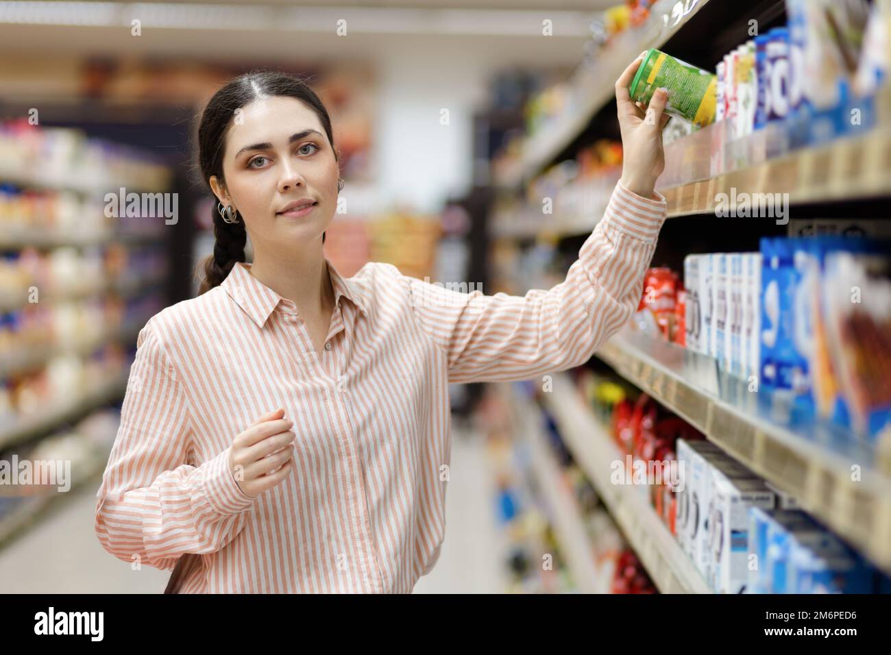 Visit grocery store. Portrait of young pretty caucasian woman takes ...