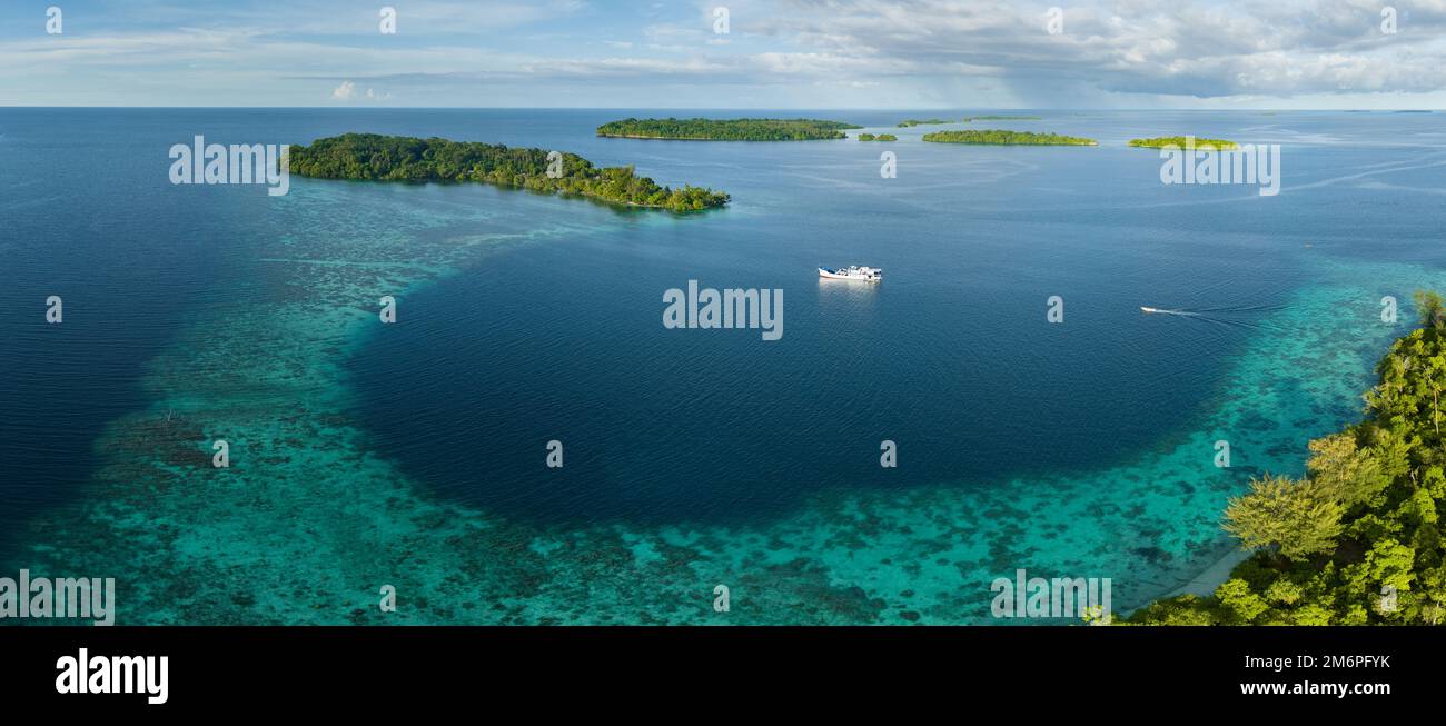 A healthy, robust coral reef surrounds a scenic bay in the Solomon ...