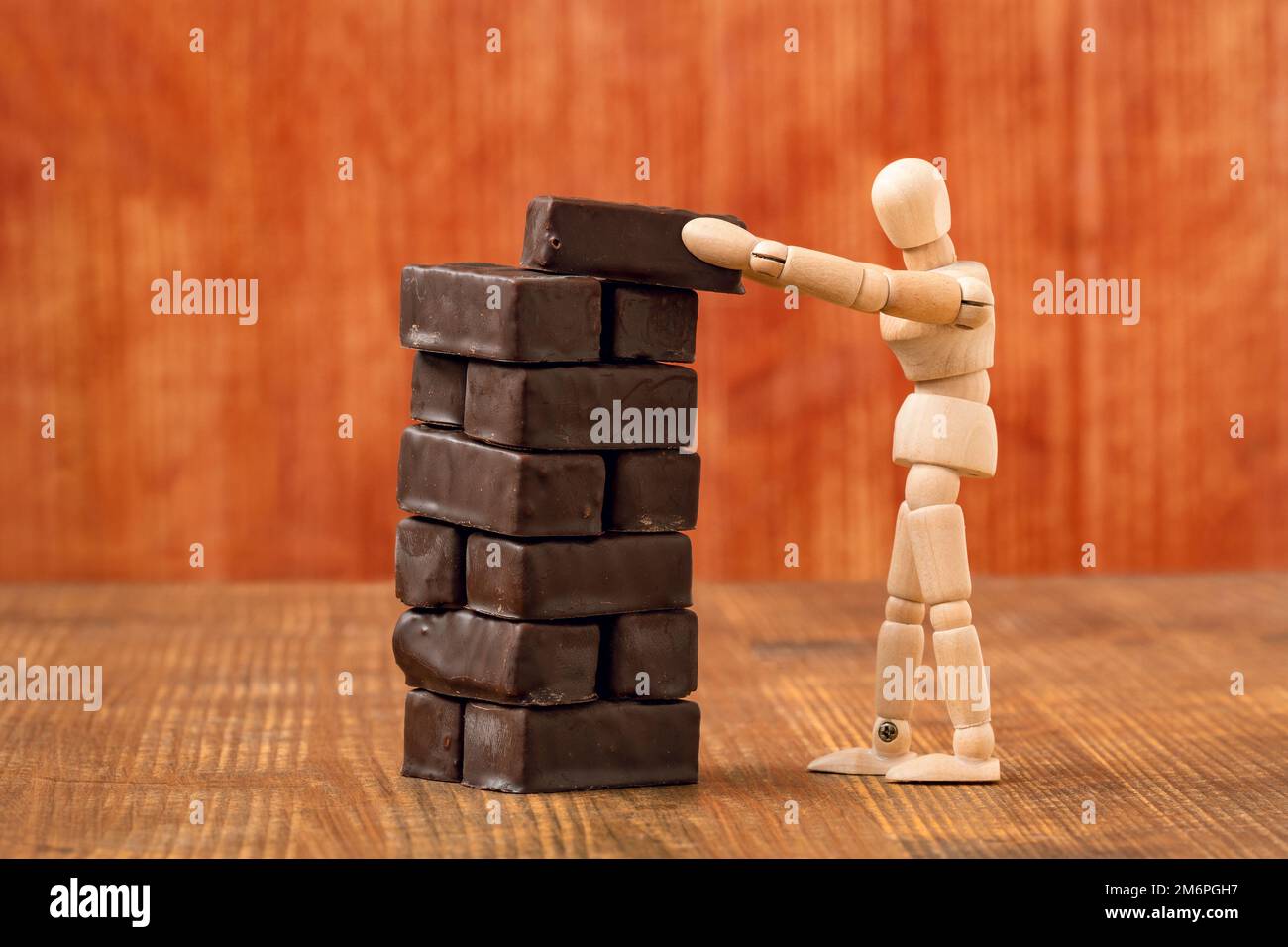 Dummy placing a chocolate candies on a candy tower Stock Photo - Alamy