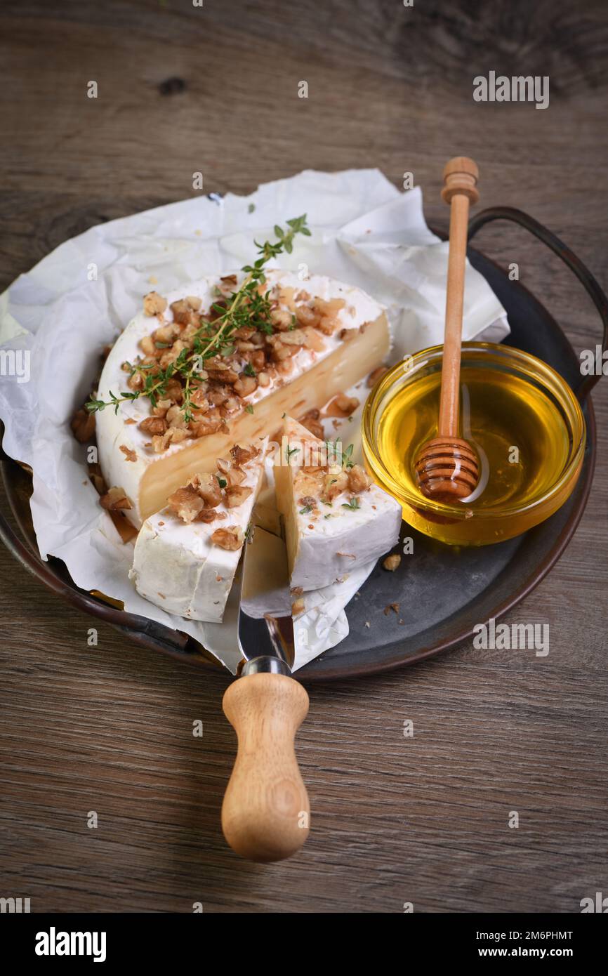 Camembert cheese with honey Stock Photo - Alamy
