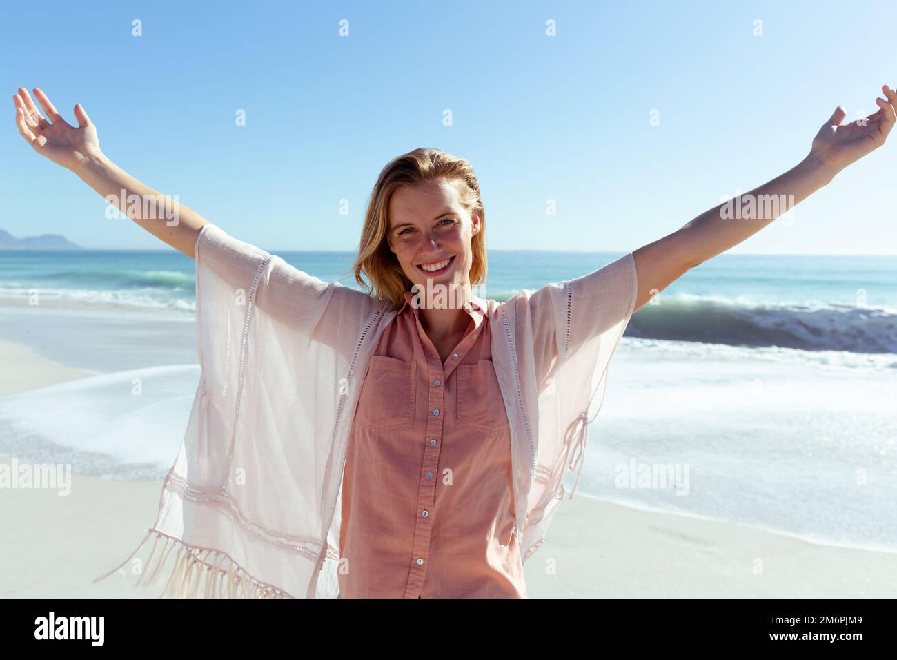 Caucasian woman enjoying time on the beach Stock Photo - Alamy